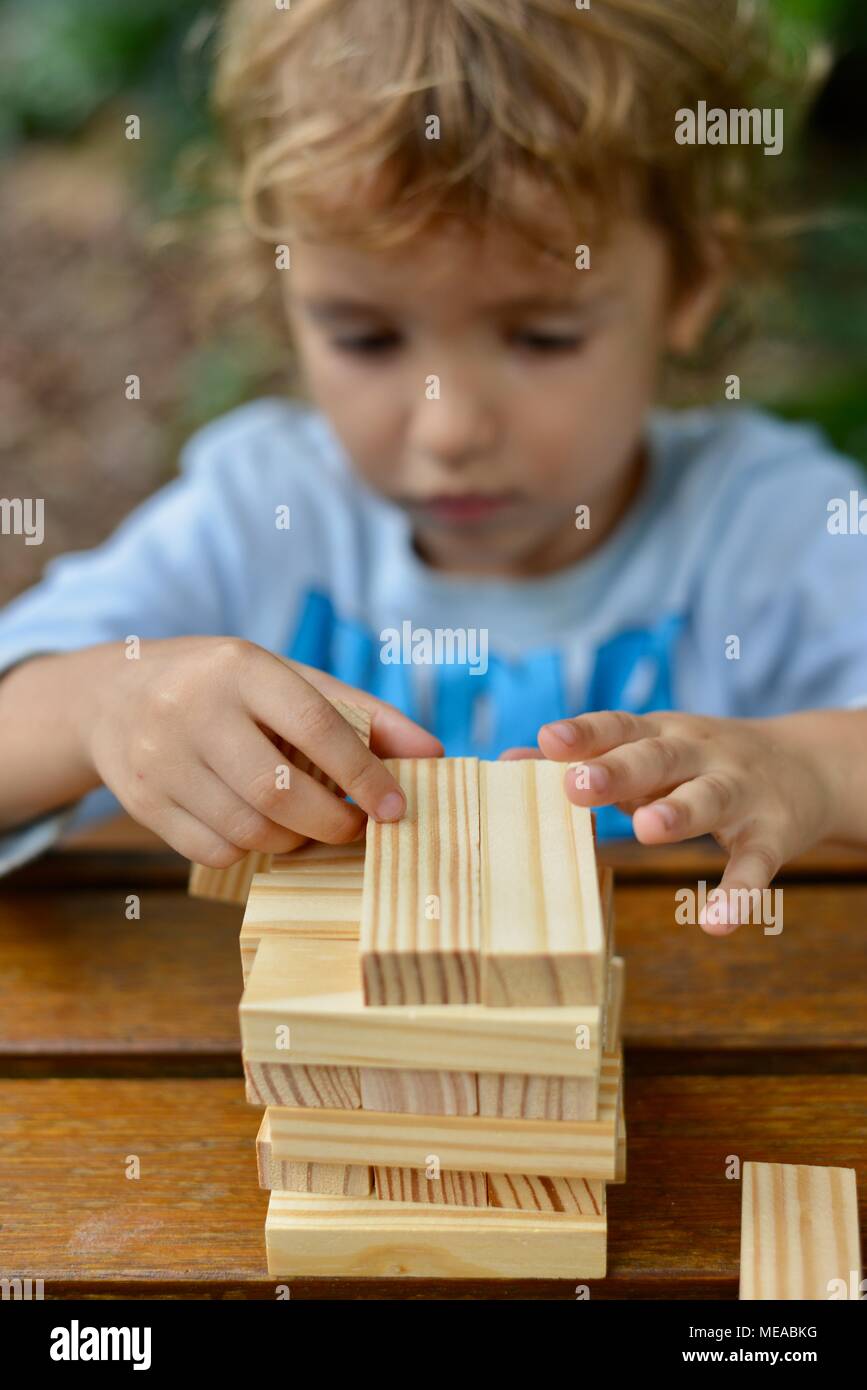 Cute child playing with building blocks and developing fine motor ...