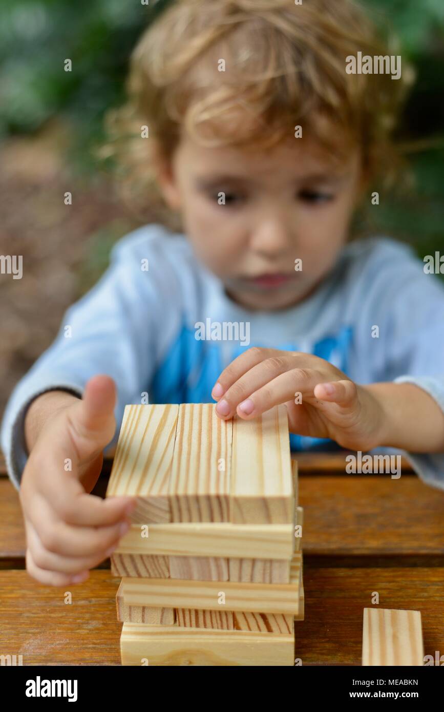 Cute child playing with building blocks and developing fine motor ... Cute child playing with building blocks and developing fine motor ...