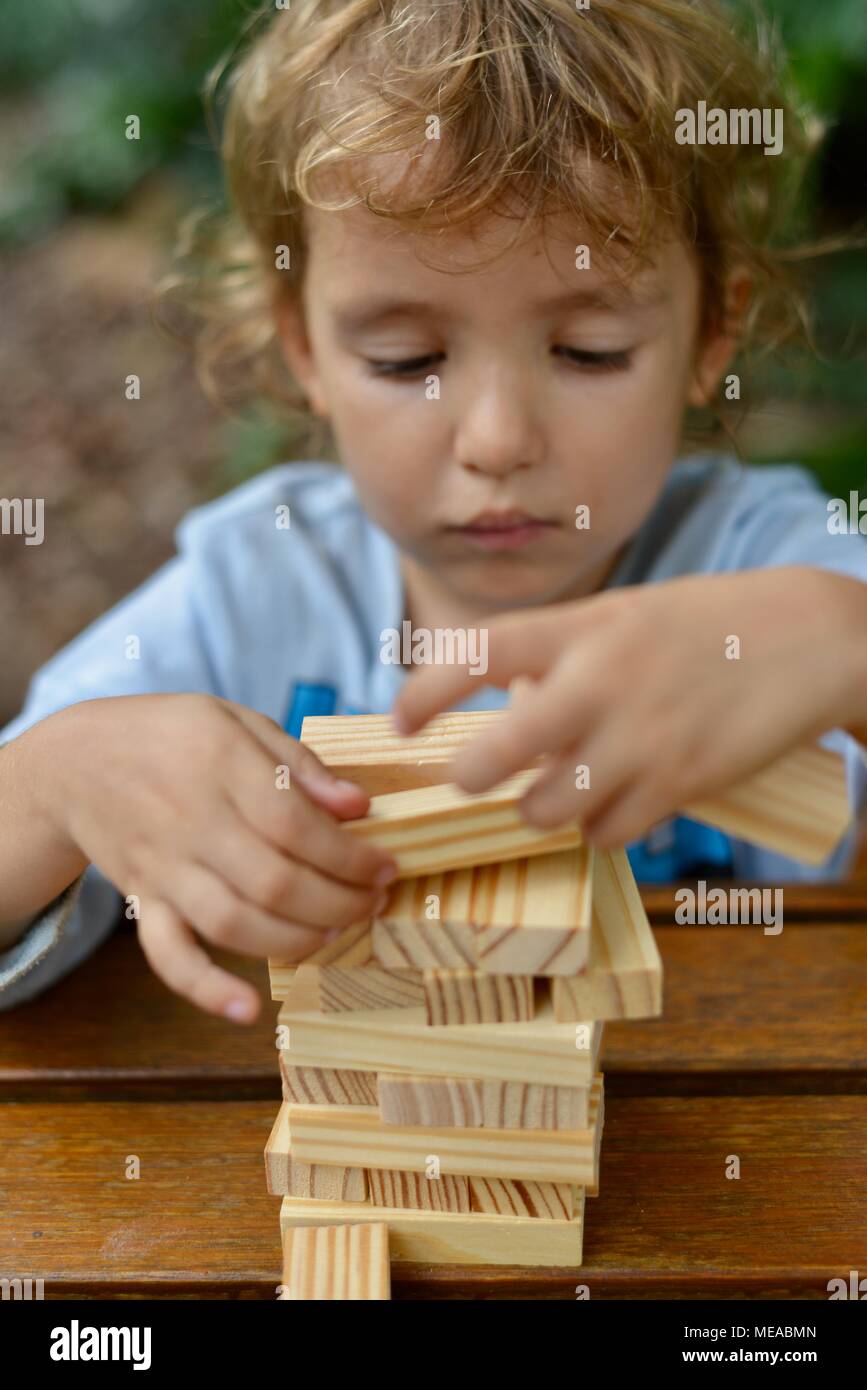 Cute child playing with building blocks and developing fine motor ... Cute child playing with building blocks and developing fine motor ...