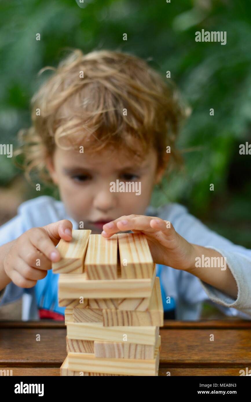 Cute child playing with building blocks and developing fine motor ...
