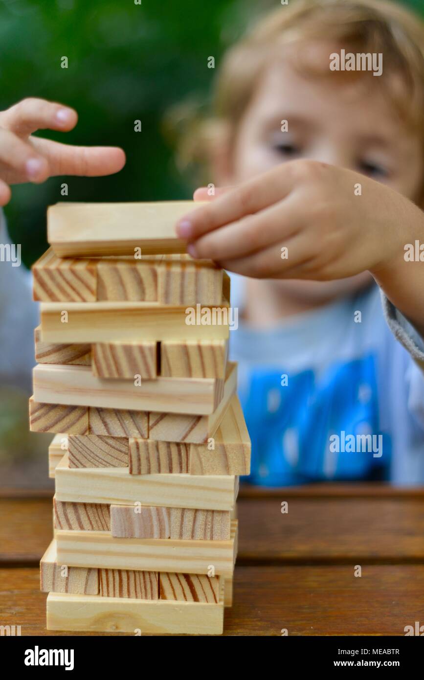Cute child playing with building blocks and developing fine motor ...