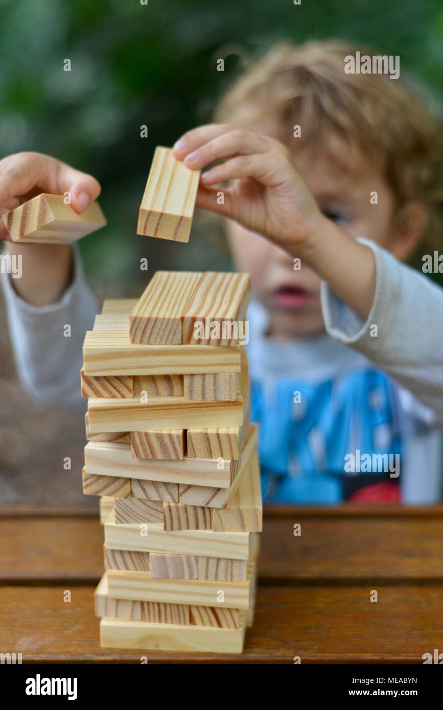 Cute child playing with building blocks and developing fine motor ...
