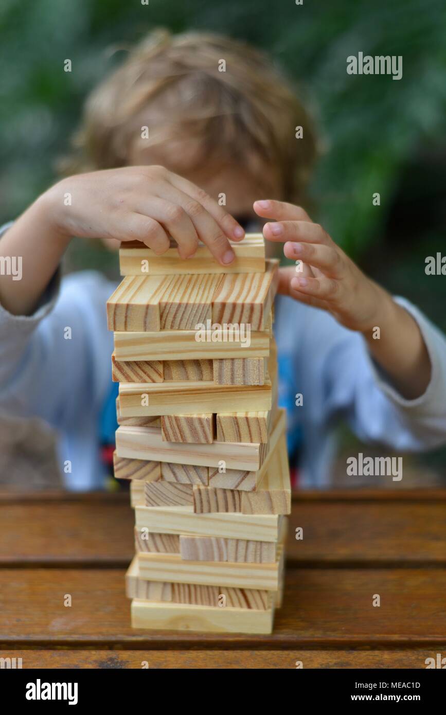 Cute child playing with building blocks and developing fine motor ...