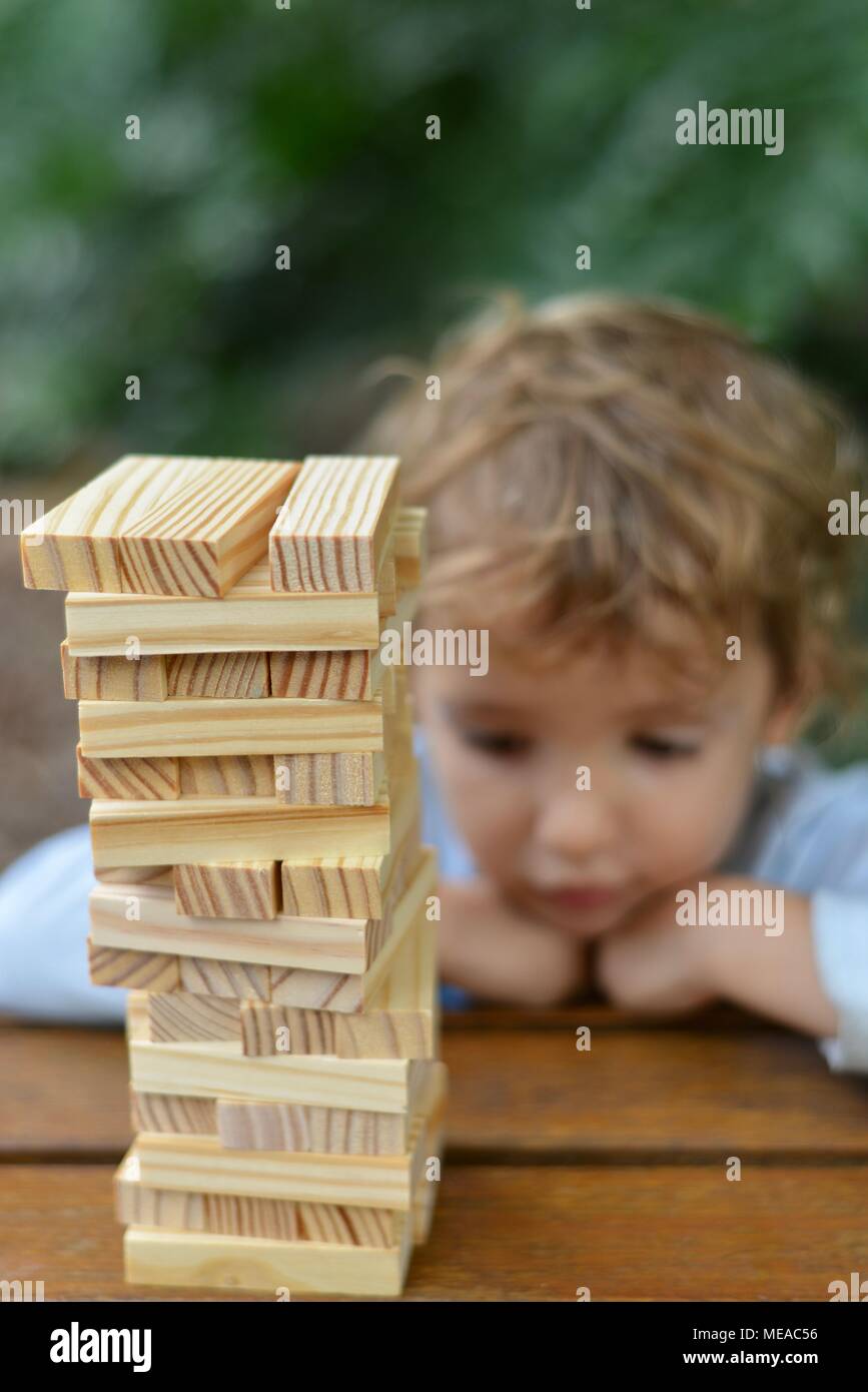 Cute child playing with building blocks and developing fine motor ... Cute child playing with building blocks and developing fine motor ...