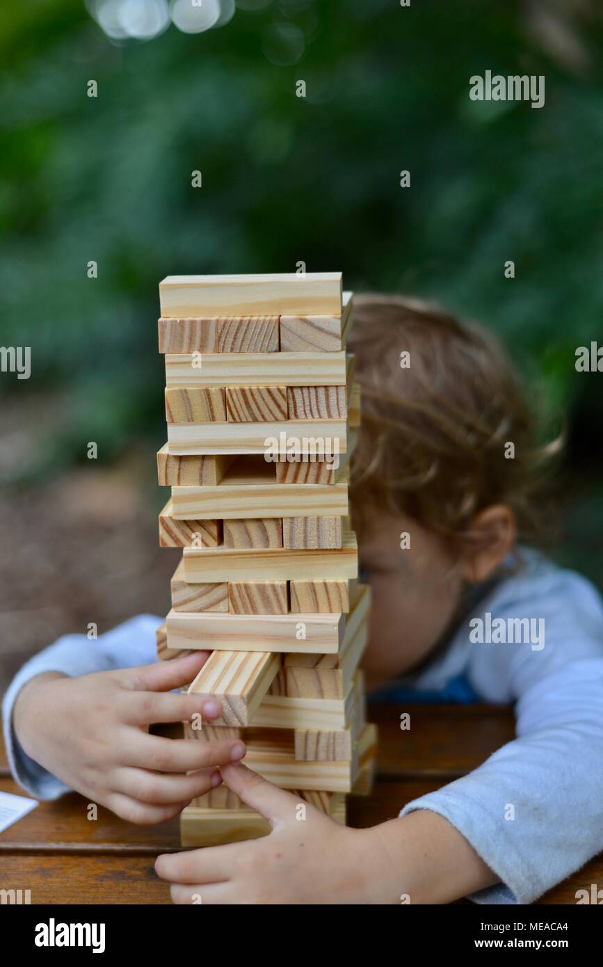 Cute child playing with building blocks and developing fine motor ...