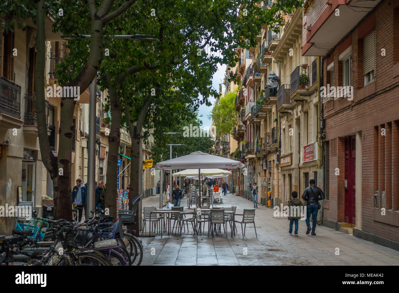 A view down Carrer de Blai in Barcelona. Tables and chairs are setup in ...