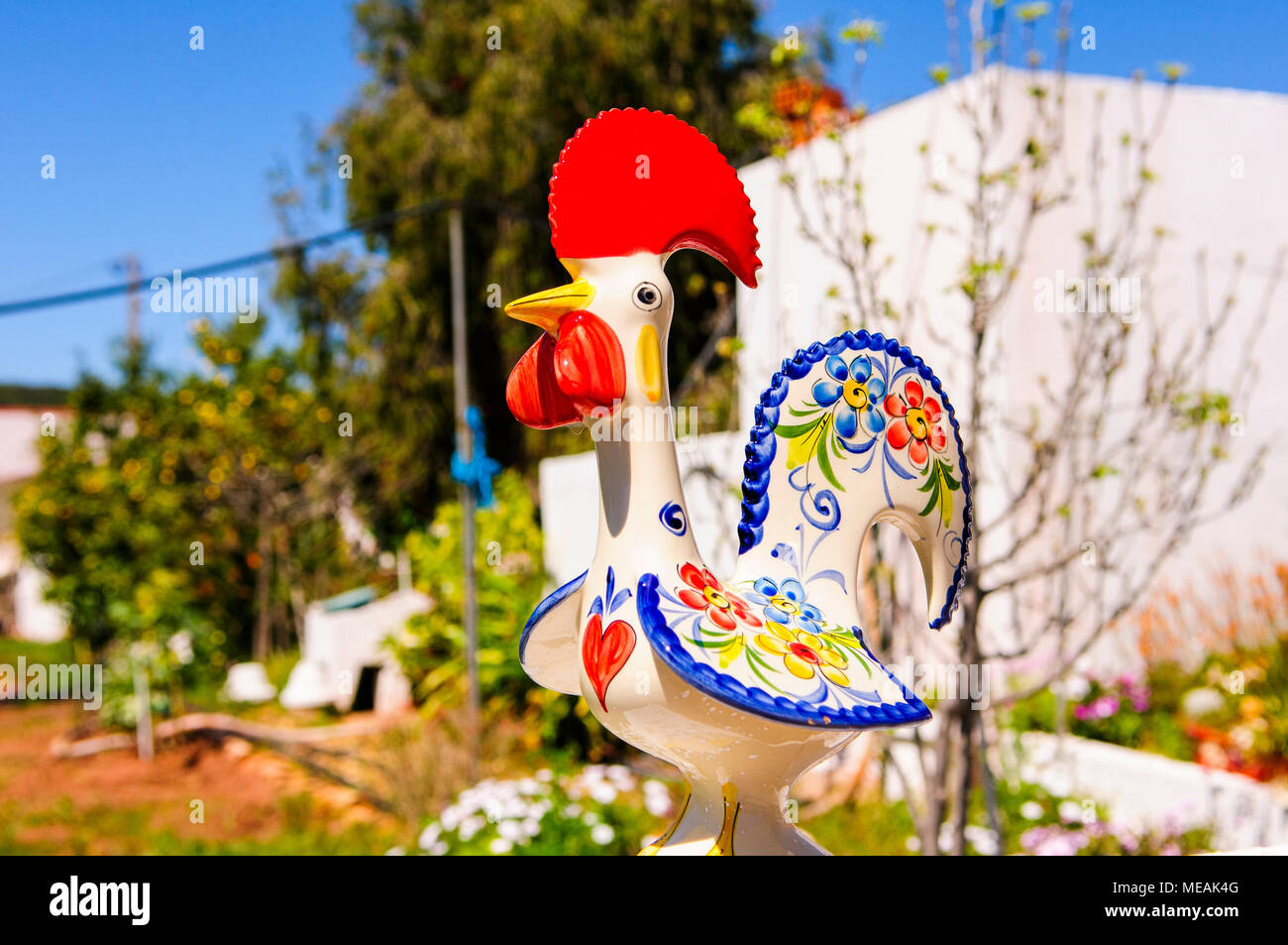 Colourful ceramic cockerel, the Portuguese national symbol, in a ...