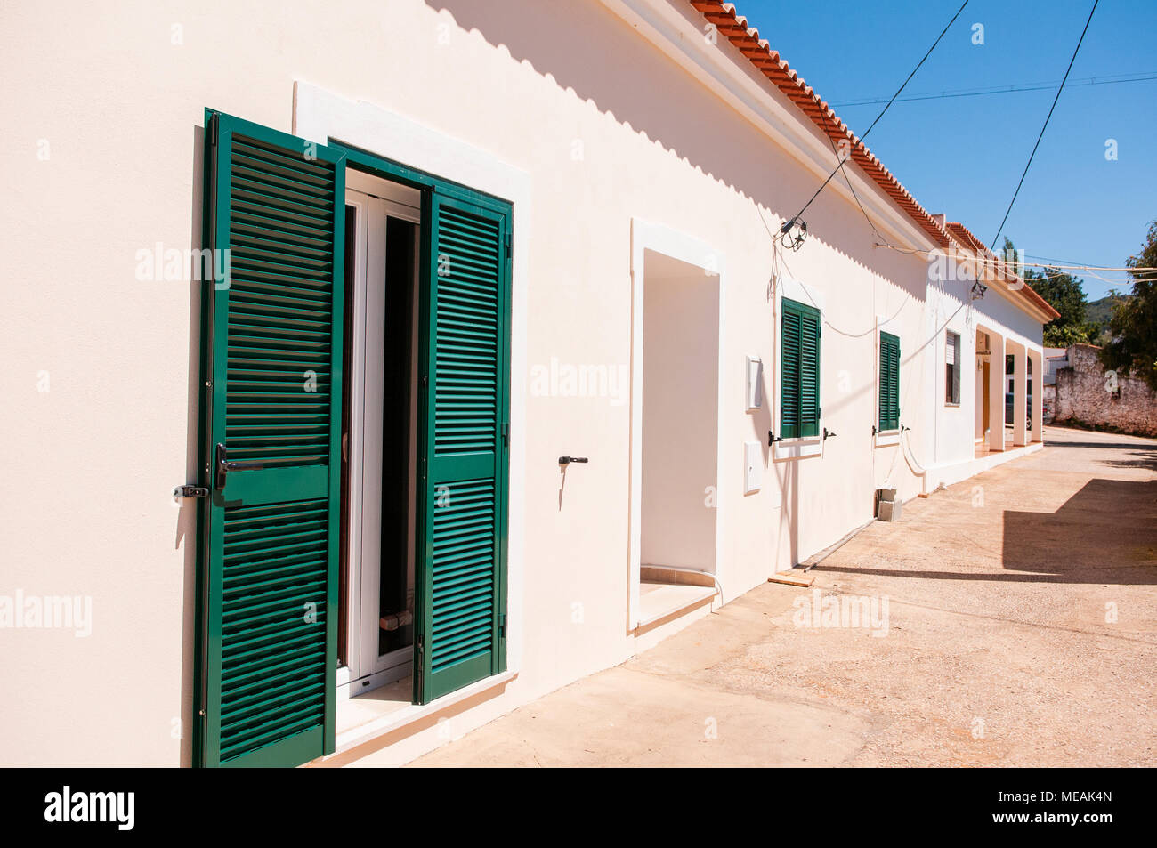 Whitewashed Portuguese farmhouse cottage with red terracotta roof tiles ...