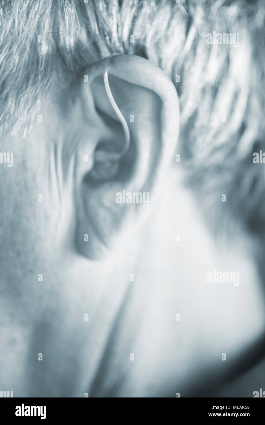 Digital modern hearing aid in the ear of aged old man Stock Photo - Alamy