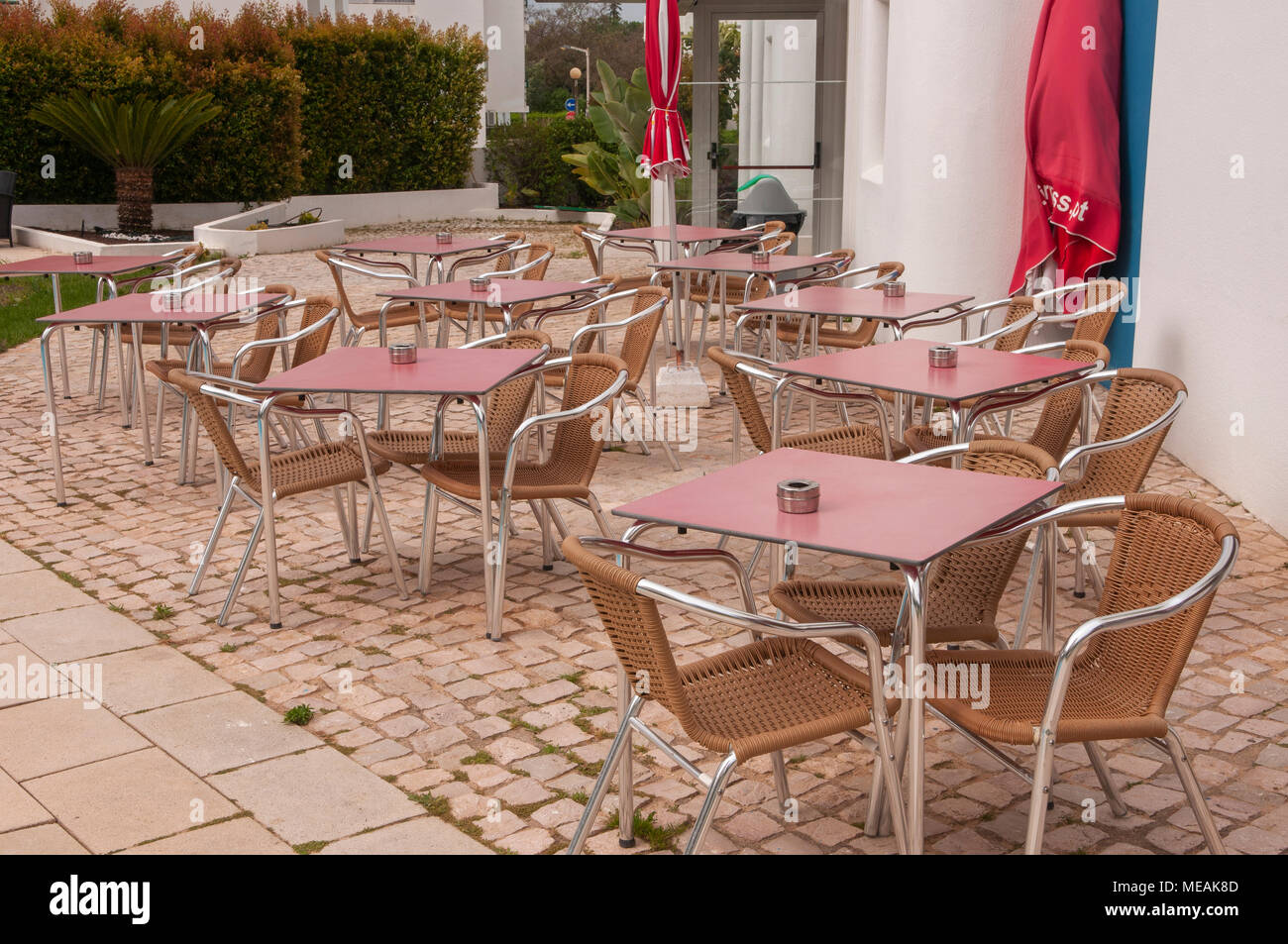 Empty tables outside a hotel in Portugal Stock Photo - Alamy