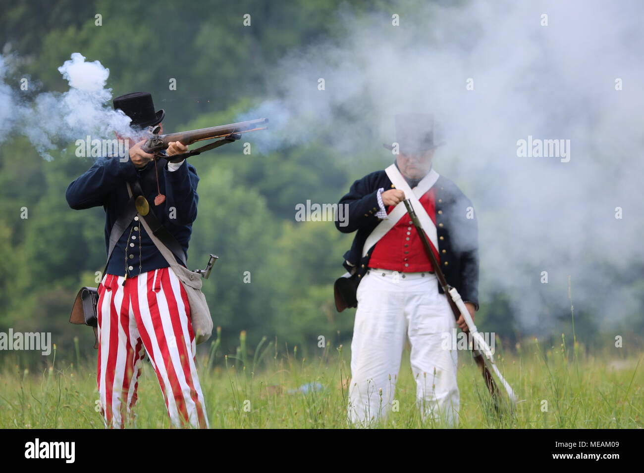 American militamen reenactors loading and firing muckets during War of ...