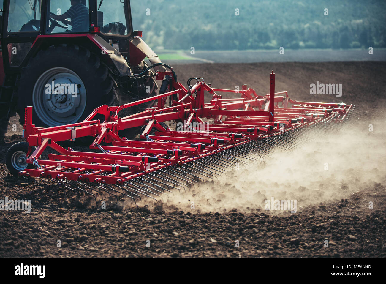 Farmer in tractor preparing farmland with seedbed for the next year ...
