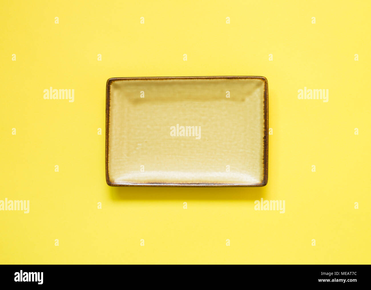 Yellow dish isolated on yellow background Stock Photo - Alamy