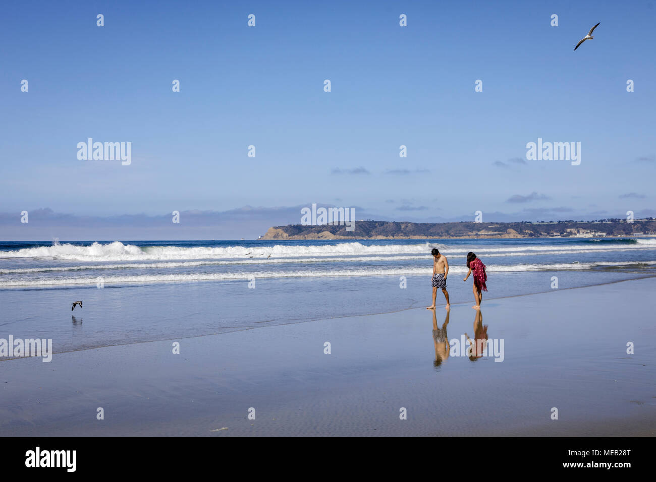 Carefree young couple spending time together of a beach Stock Photo - Alamy