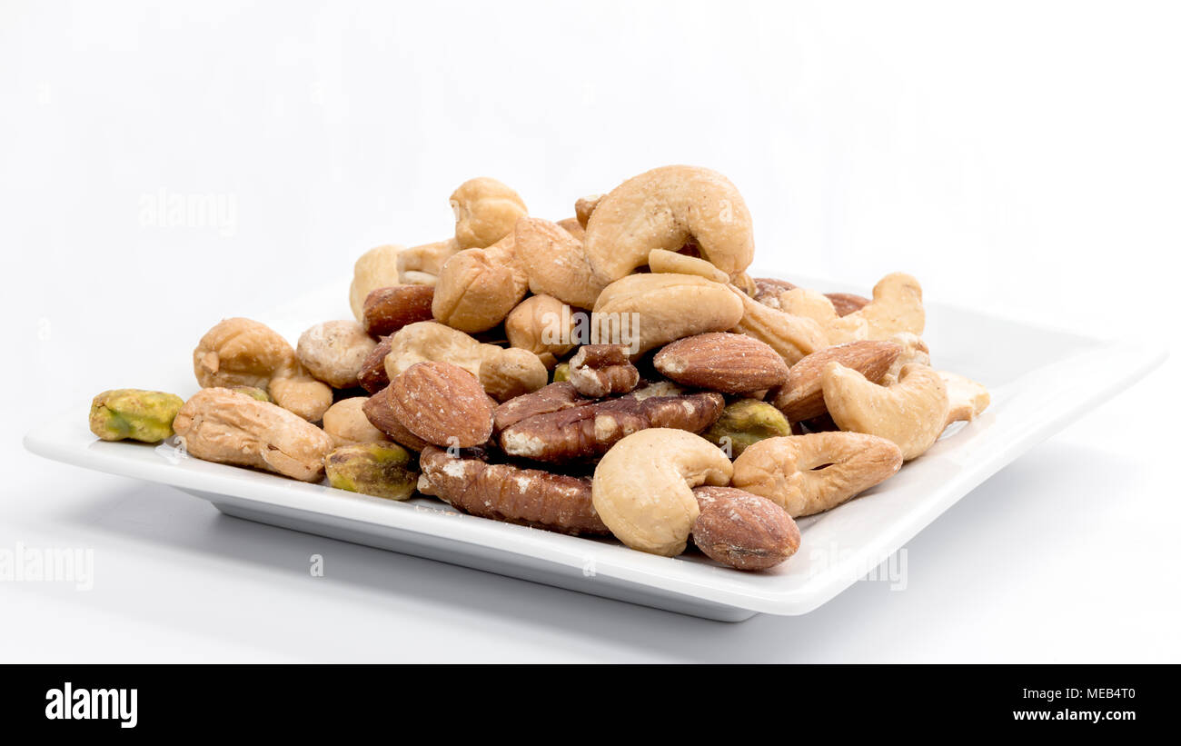 Small plate with a snack of nuts on it Stock Photo - Alamy