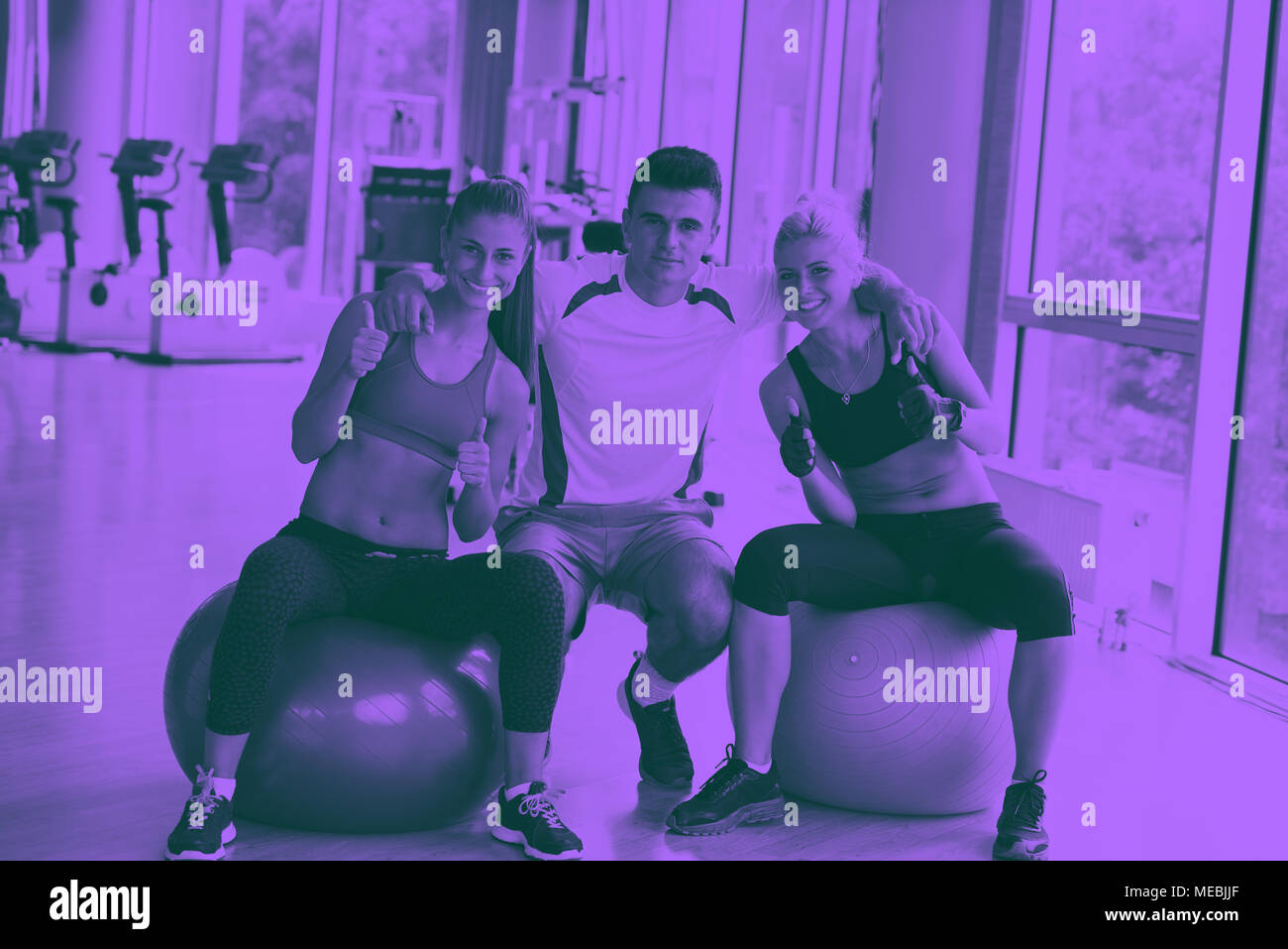 group portrait of healthy and fit young people in fitness gym duo tone ...