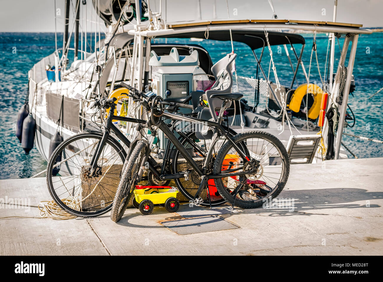 Bicycles Parked on jetty in front of sailing boat. Stock Image Stock ...