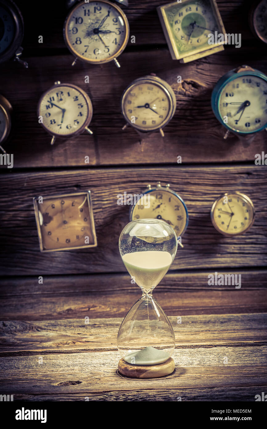 Hourglass as the old way of timing on clocks backgrounds Stock Photo ...