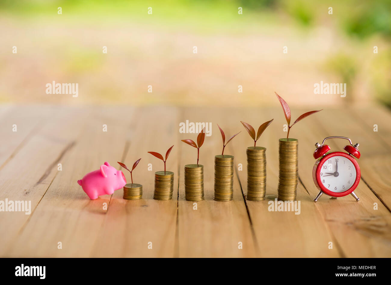Alarm clock and piggy bank concept for saving time Stock Photo - Alamy