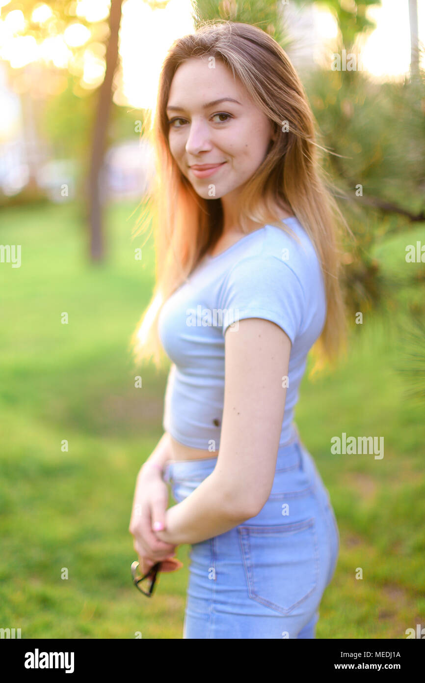 Cute photo model near cedar wood in green grass background Stock Photo ...