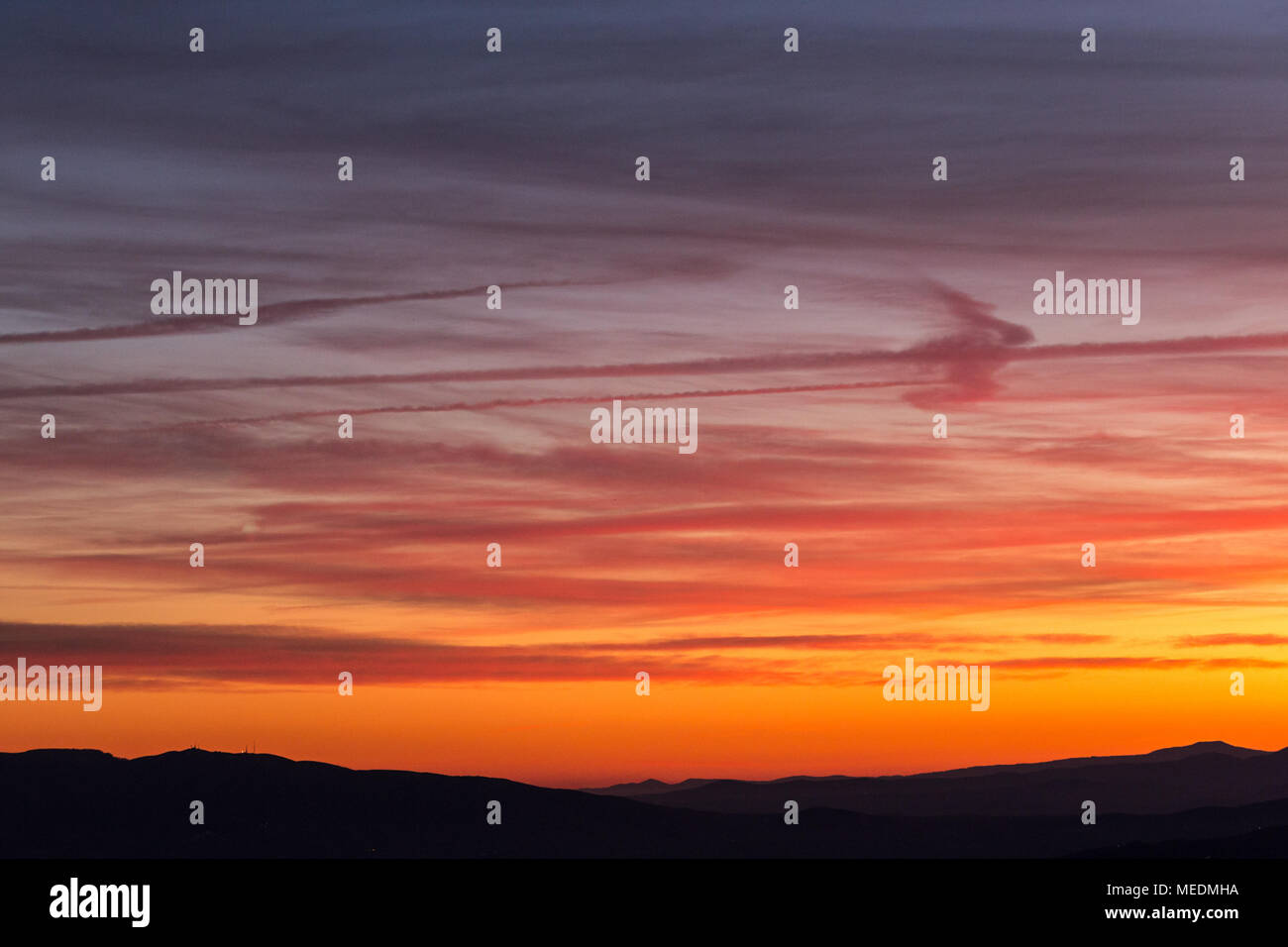 Clouds and jet vapor trails creating beautiful, colorful texture in the ...