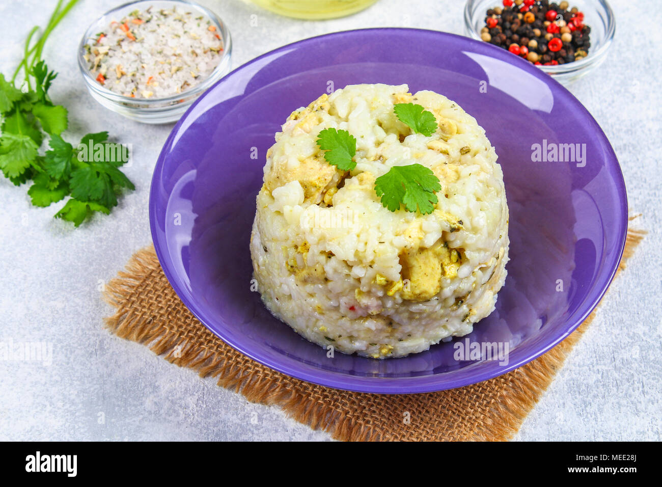 White steamed rice with slices of fried chicken fillet in a bowl on a ...