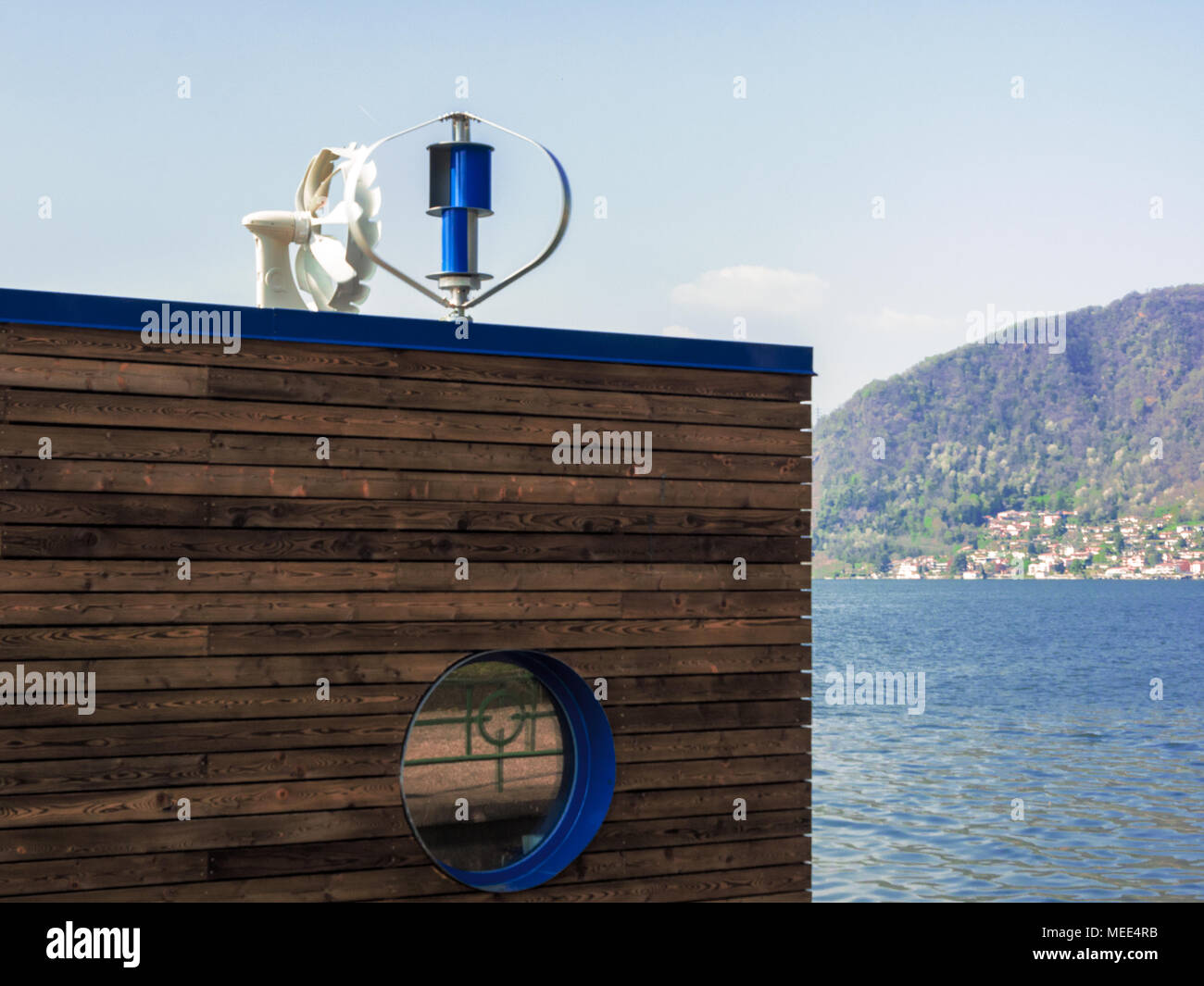 small wind farm installed on a wooden structure on the lake Stock Photo ...
