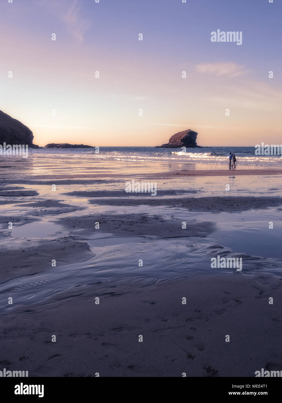 View across the sands to Gull Rock, Portreath, Cornwall, as the sun ...