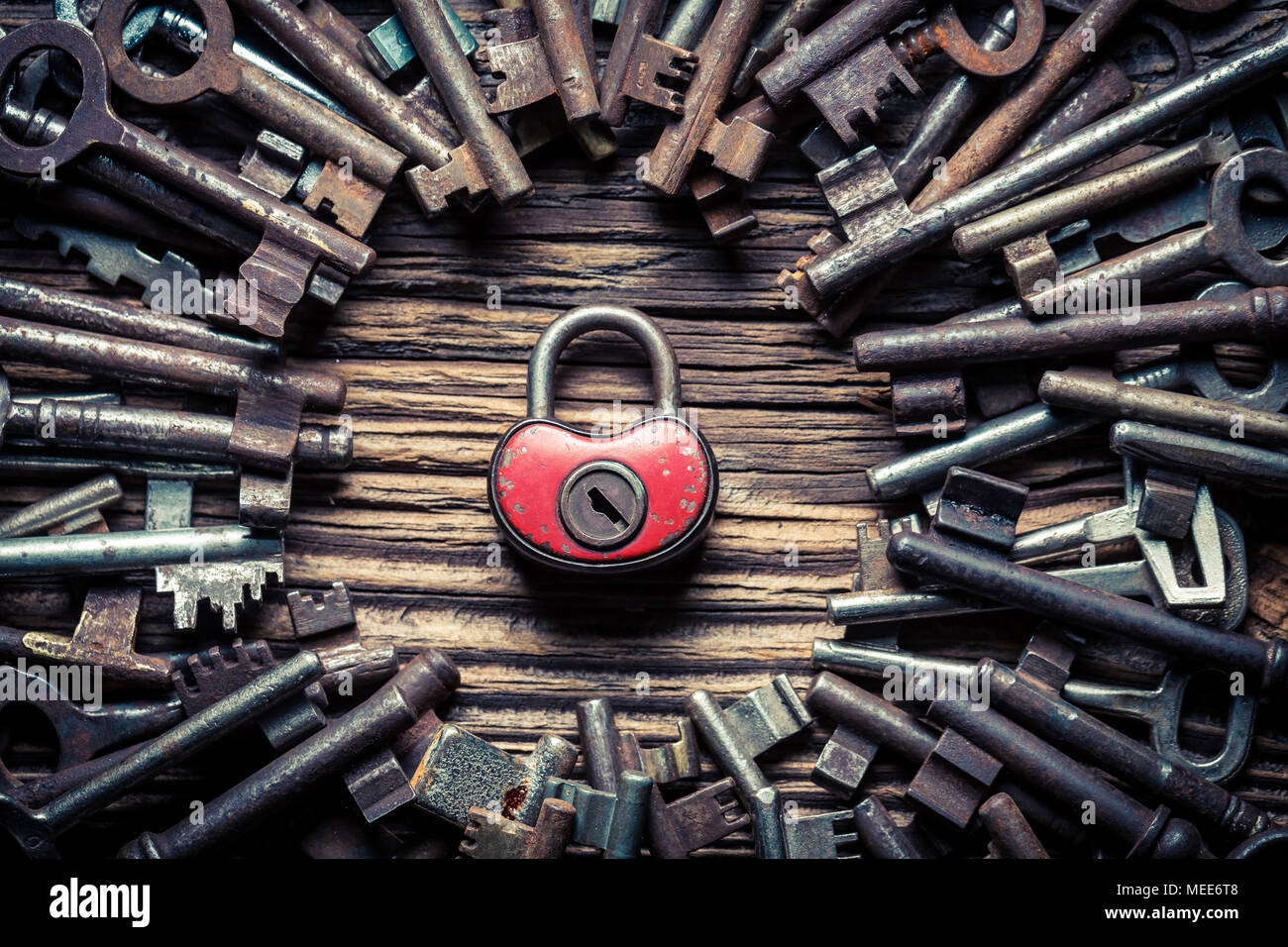 One red lock and many old keys as concept Stock Photo - Alamy