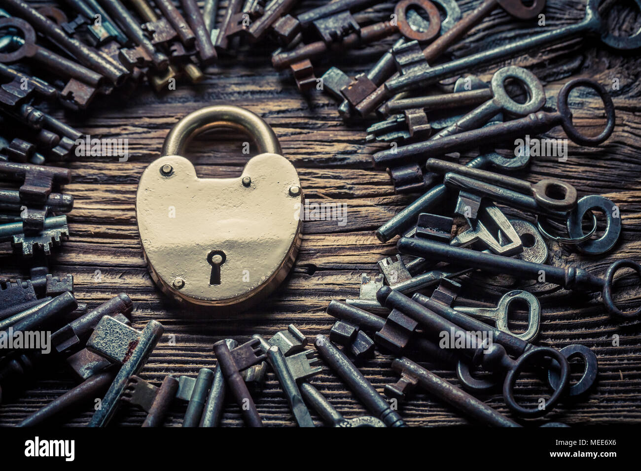 One golden lock and many old keys as concept Stock Photo - Alamy