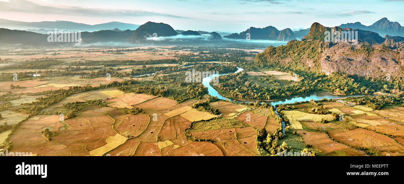 Aerial bird's-eye sunrise time view on valley landscape with karst ...