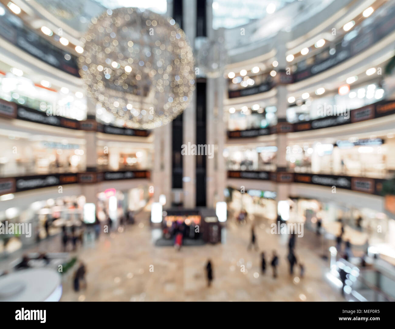 Shopping mall blur background with bokeh. Blurred hall and several ...