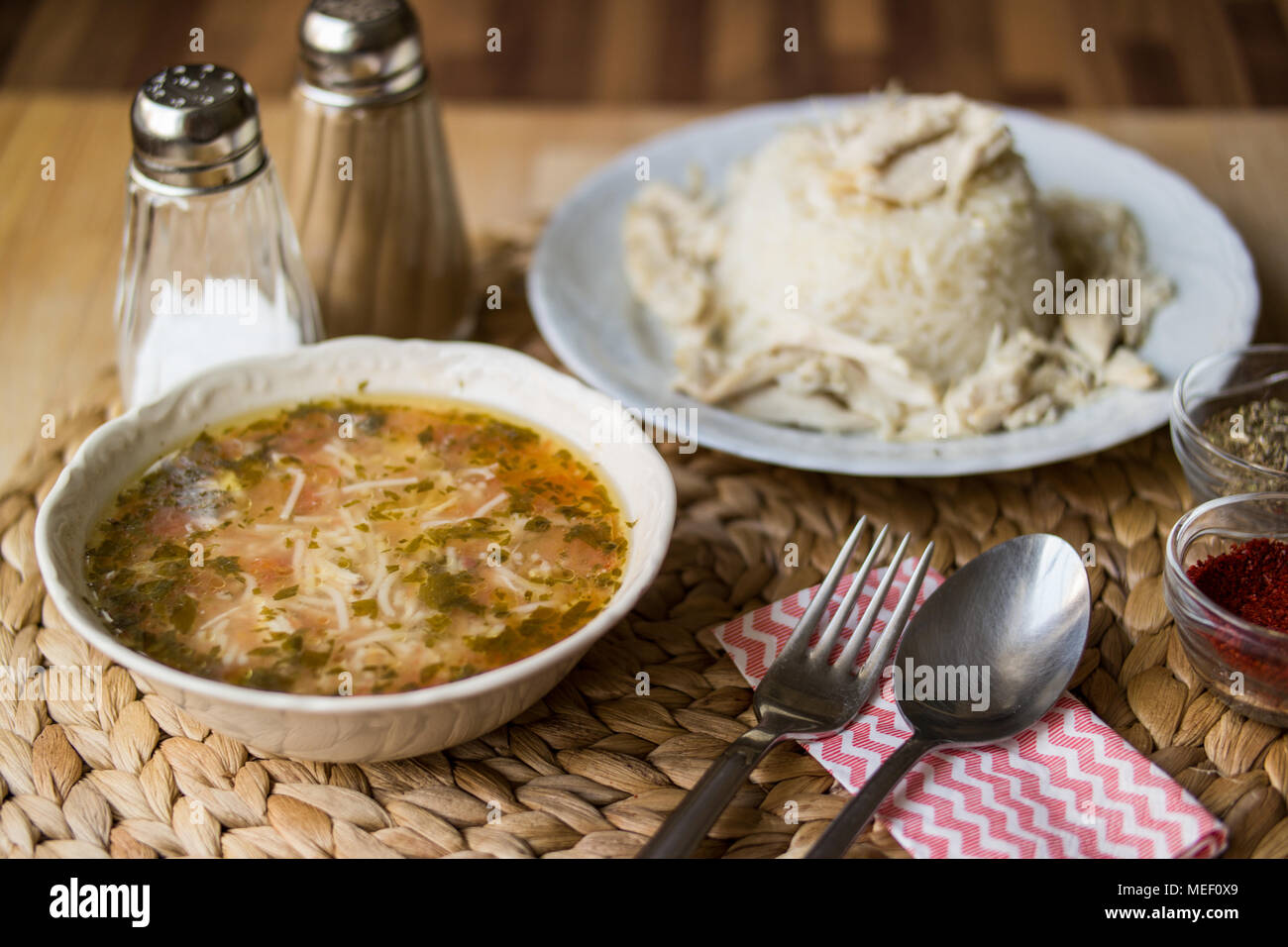 Traditional Turkish chicken broth soup with chicken on a rice pilaf ...