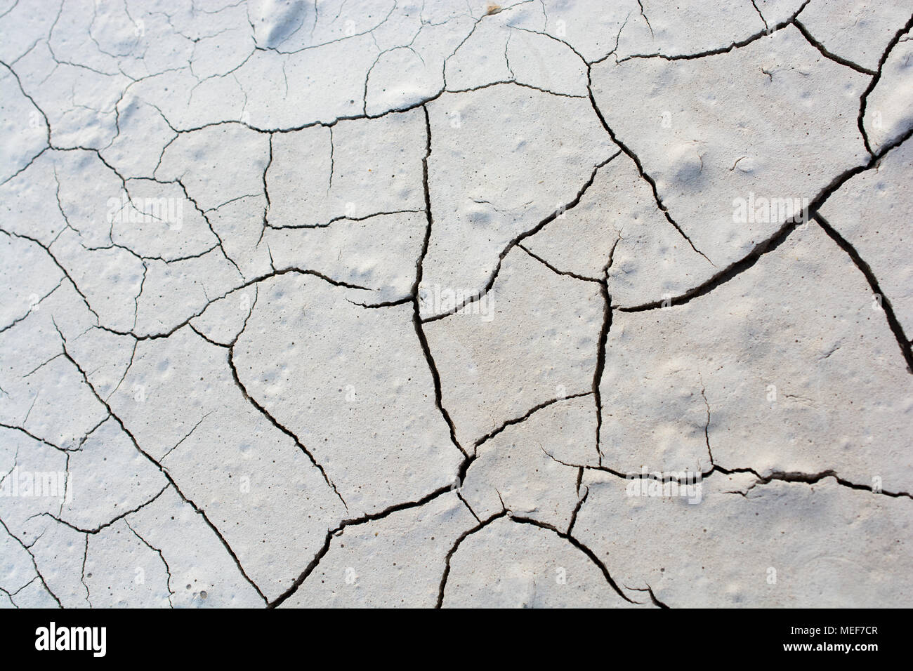 Grey color dry cracked muddy earth as a background texture Stock Photo ...