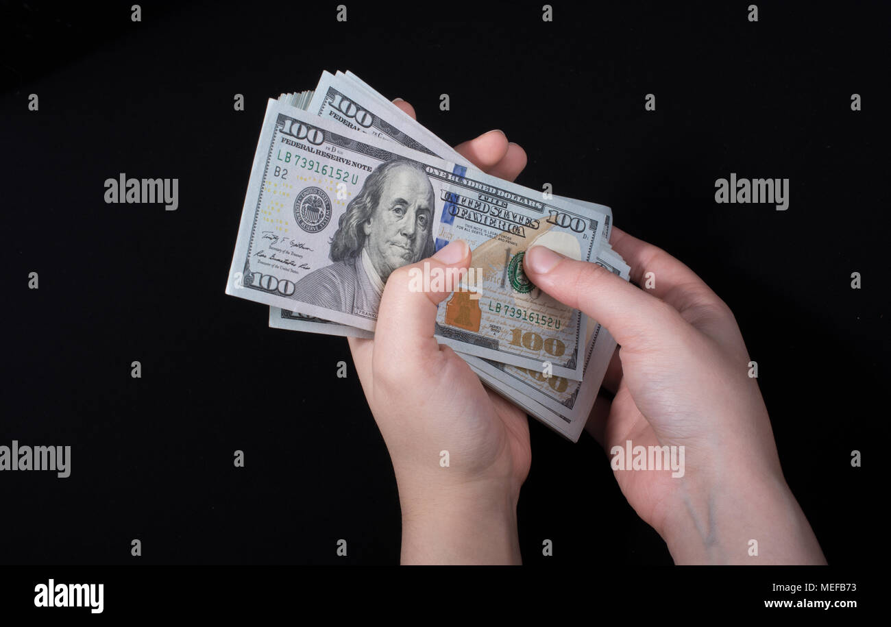 Hand holding American dollar banknotes isolated on white background ...