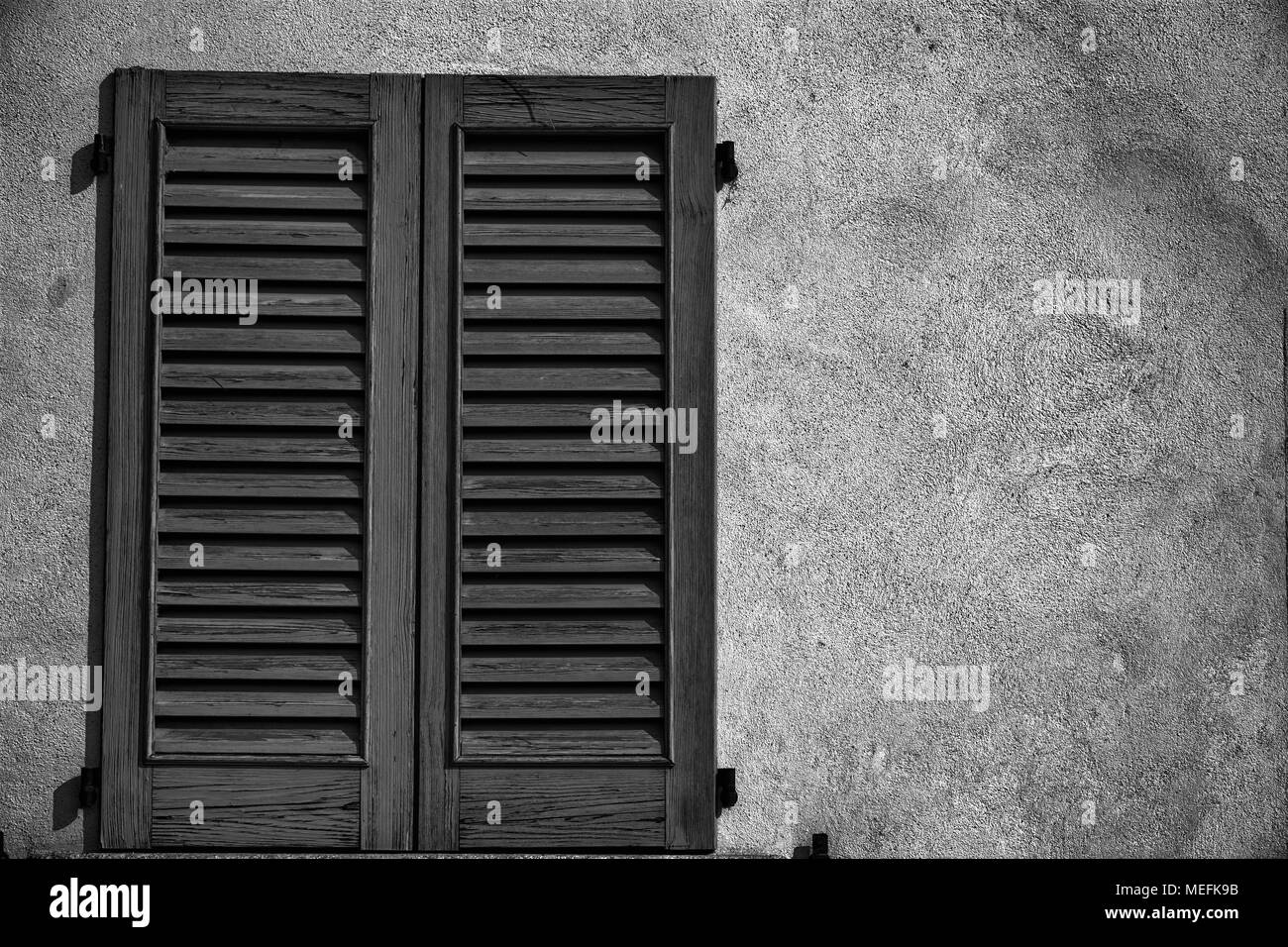 Close vintage window shutter in sunny day, italy style concrete cement ...