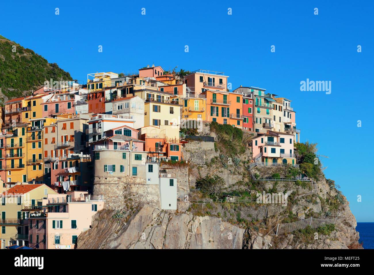 Italian style resident buildings over cliff in Manarola in Cinque Terre ...