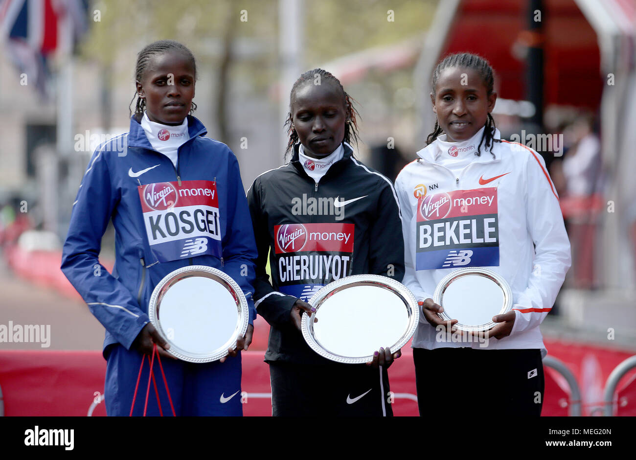 Kenya's Vivan Cheruiyot (centre) poses with the trophy after winning ...