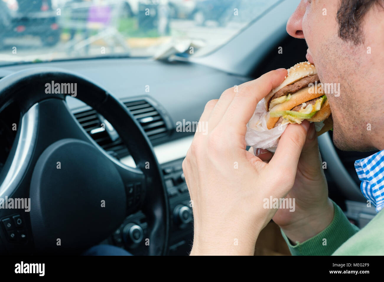 Man Eating Fast Food In A Car