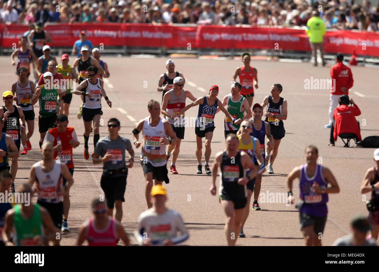 A runner is helped to the finish line during the 2018 Virgin Money ...