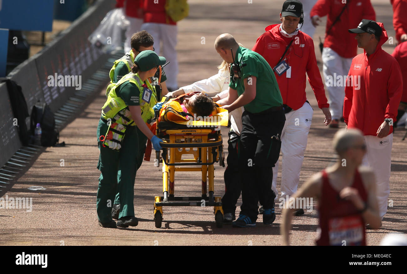 A runner on a stretcher is helped by medical staff during the 2018 ...