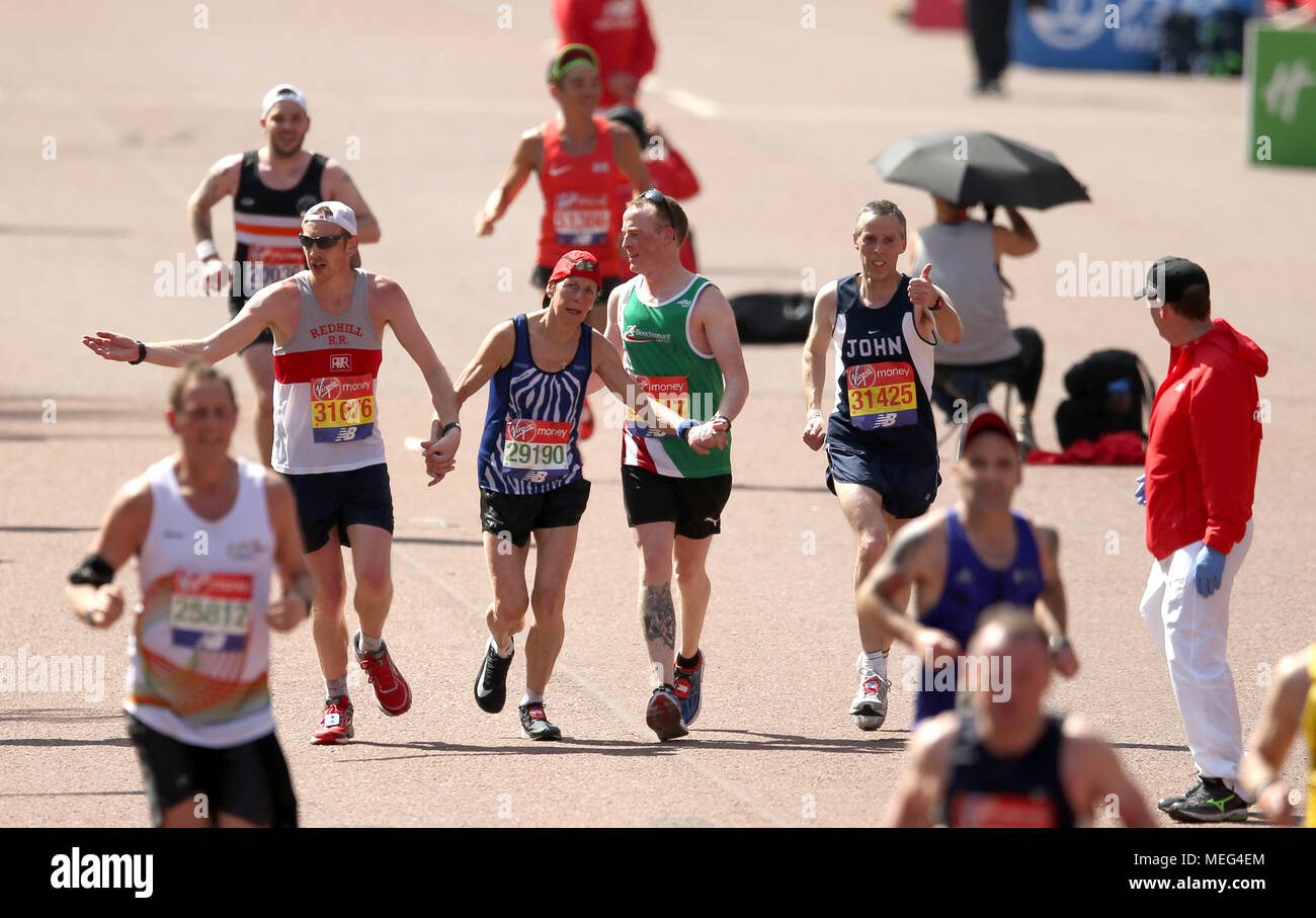 A runner is helped to the finish line during the 2018 Virgin Money ...