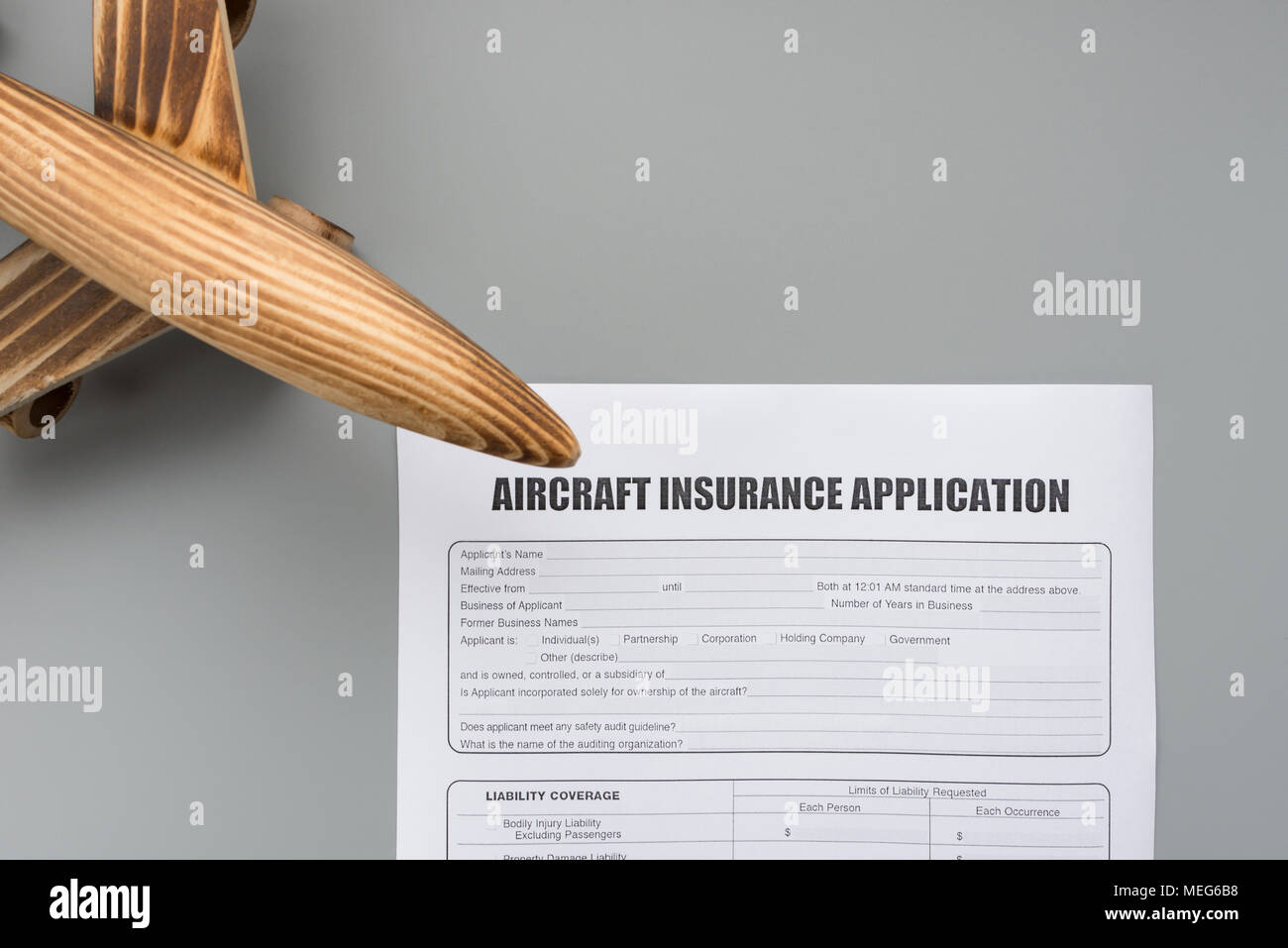aircraft insurance application and an airplane model close up concept ...