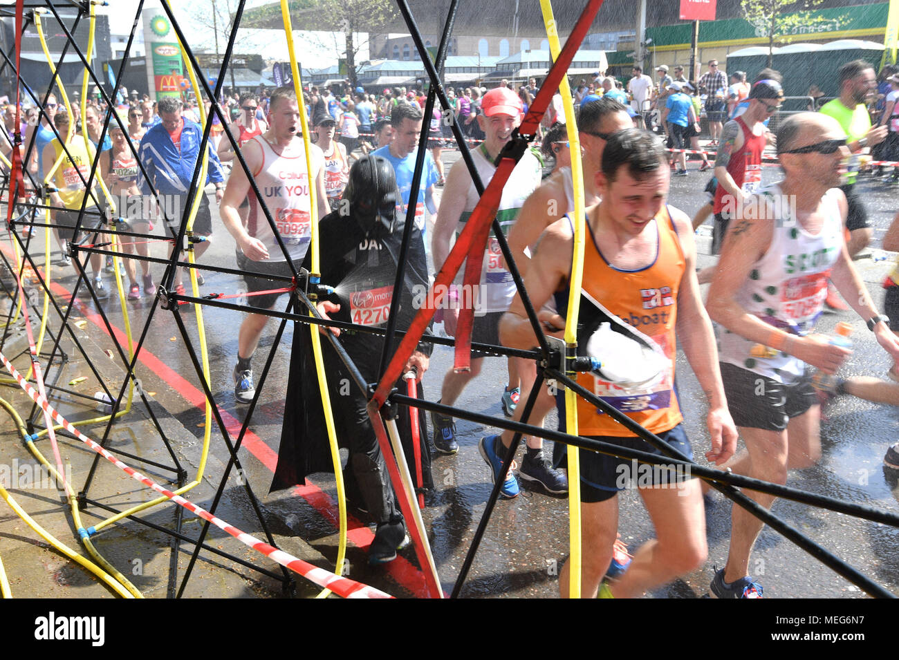 A runner dressed as Darth Vader uses showers to cool off during the ...