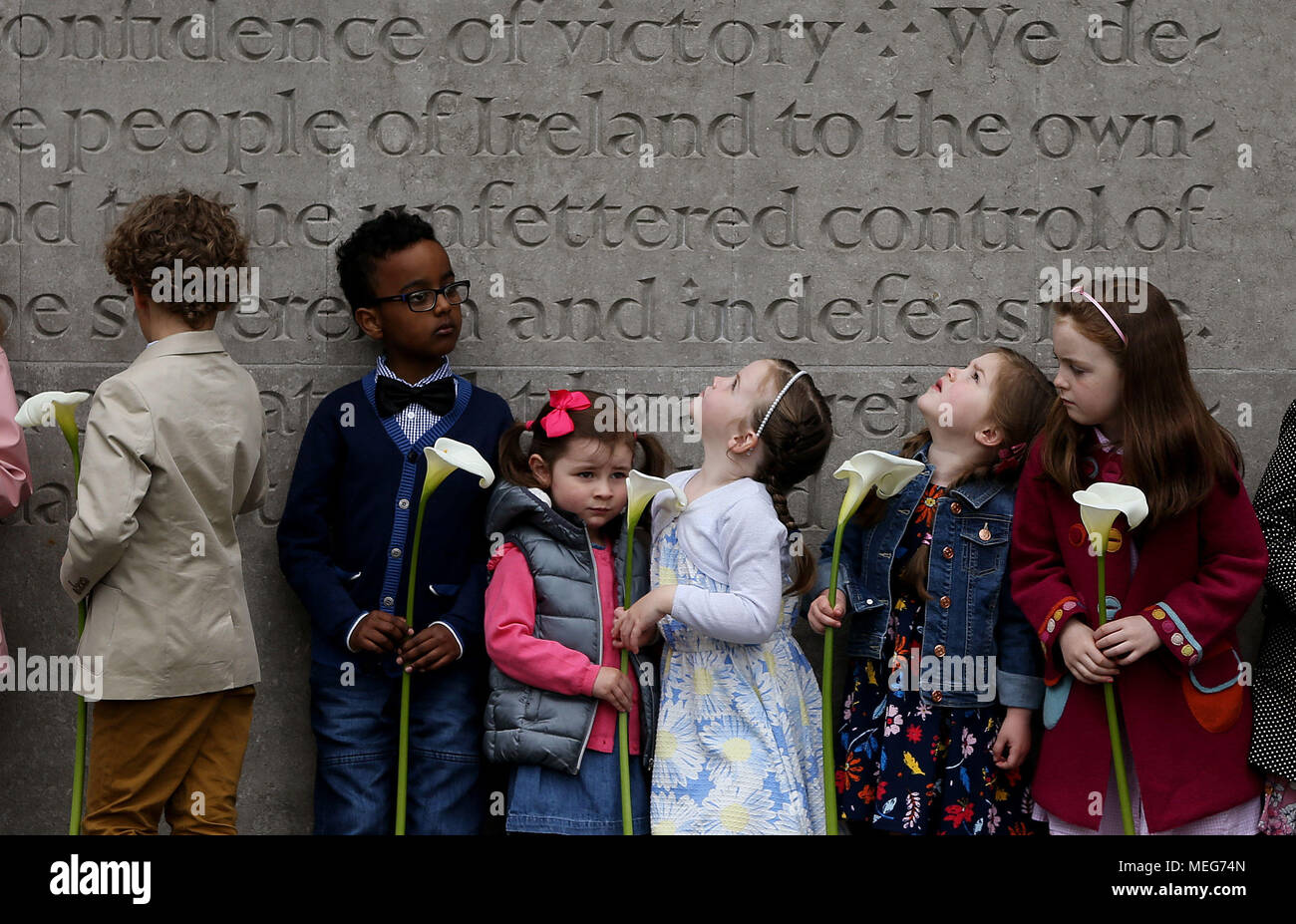 Children wait to place an Easter Lily, a symbol of the 1916 Easter ...