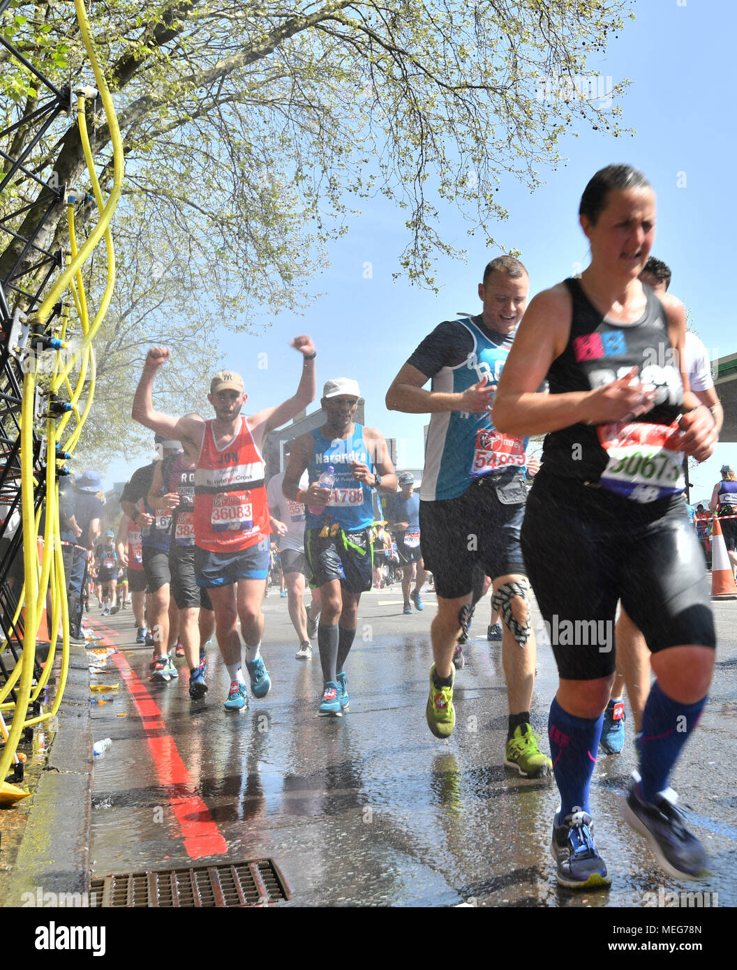 Runners use showers to cool off during the 2018 Virgin Money London ...