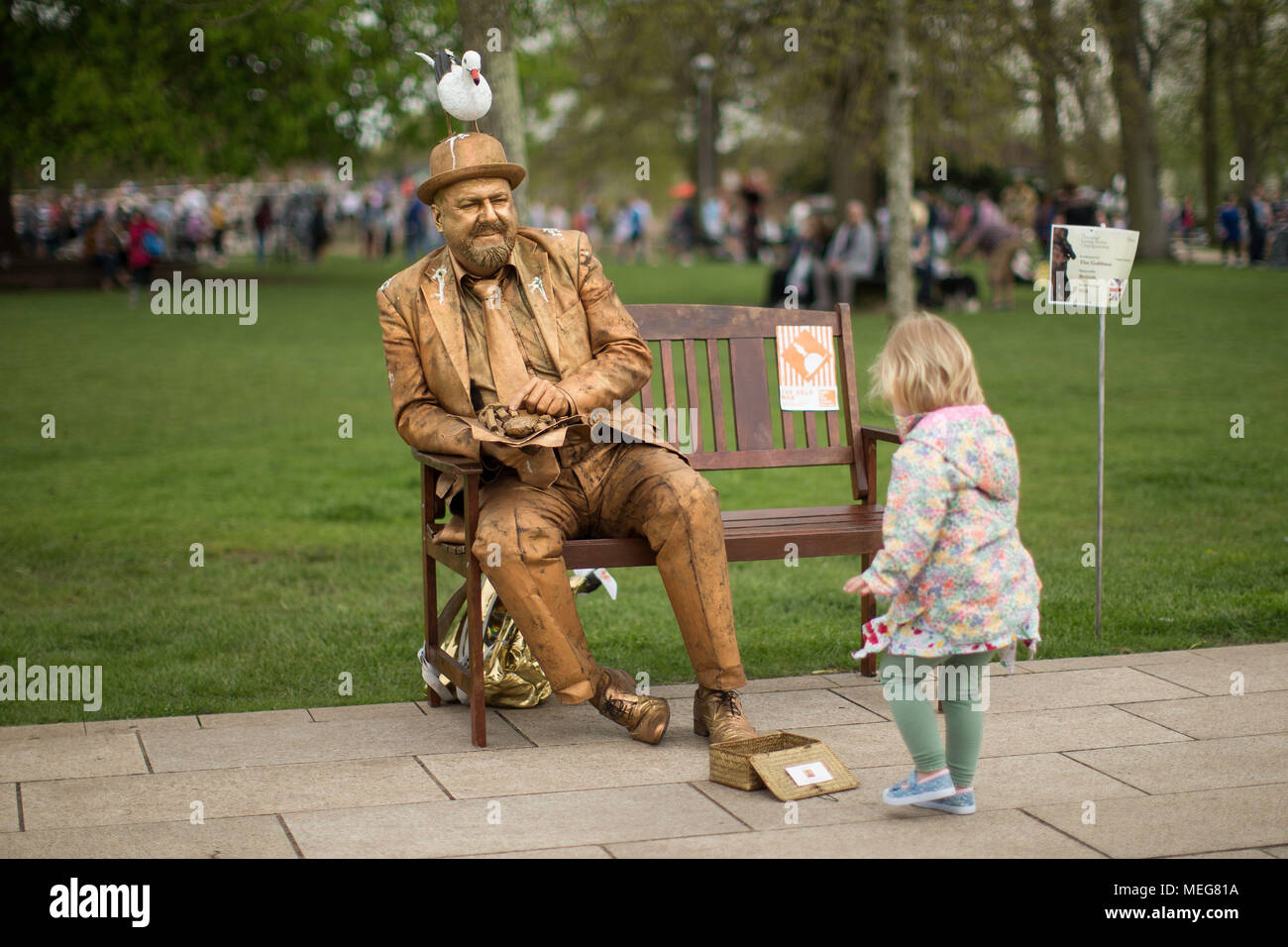 A young girl looks at British performer The Goldman during the National ...