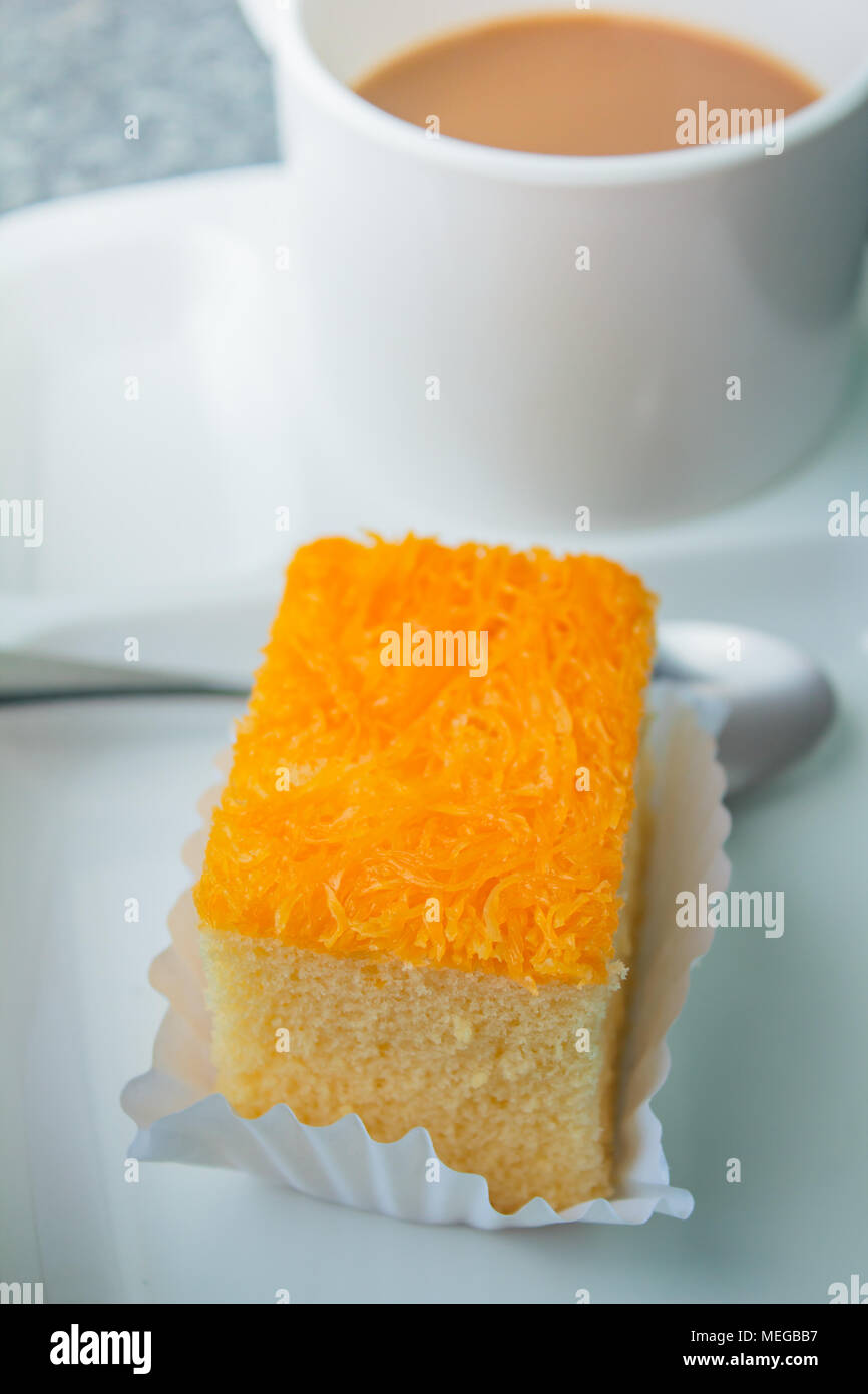Coffee break time with cake foi thong Stock Photo - Alamy