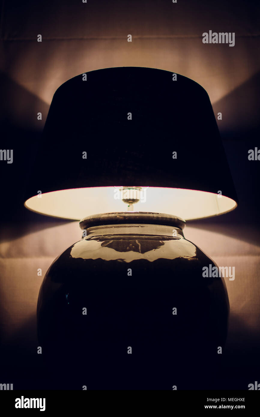 Lamp night light in a dark background. Vintage effect style picture ...