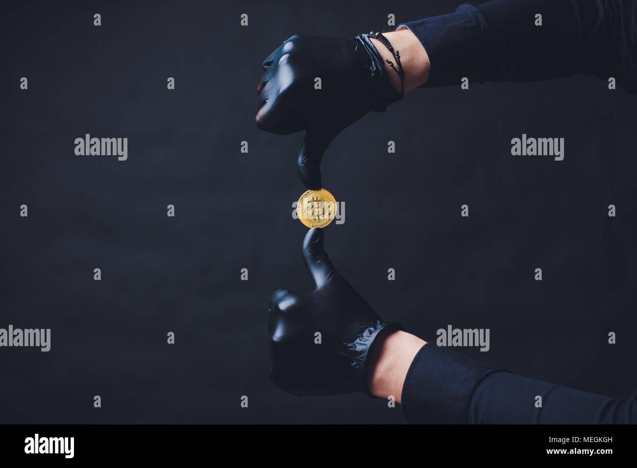 Bitcoins placed on arm Hands in black gloves show symbol Stock Photo ...